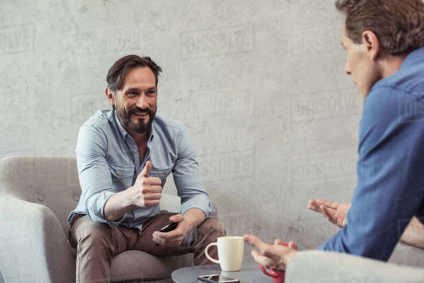 middle aged businessmen talking during meeting at coffee break ...