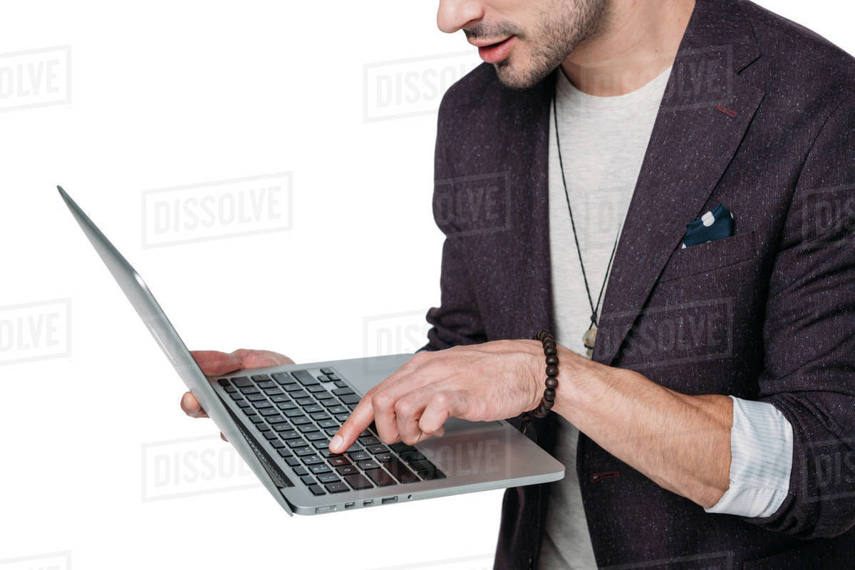 Cropped shot of stylish man typing on laptop isolated on white ...