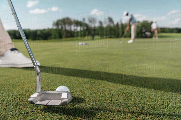 Close up of golf club and ball before shot on green - Stock Photo ...