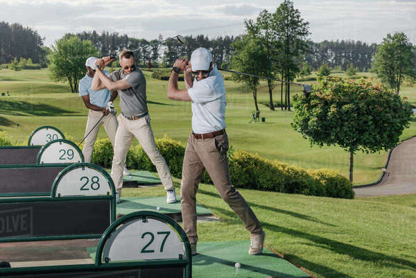 Group of golf players playing golf together at golf course - Royalty ...