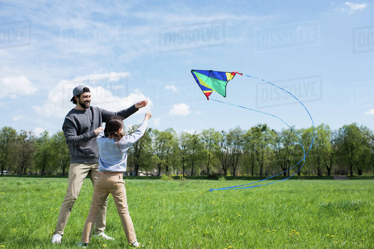 Father and daughter flying kite in park - Royalty-free Stock Photo ...