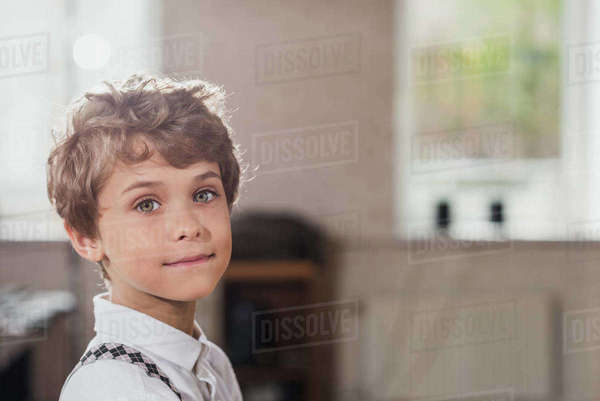 Smiling little kid looking at camera at barbershop - Stock Photo - Dissolve