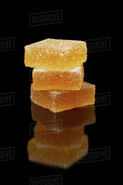 Close-up view of stack of jelly candies on black background - Stock ...