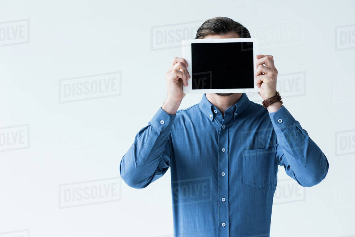 Man covering face with tablet with blank screen isolated on white ...