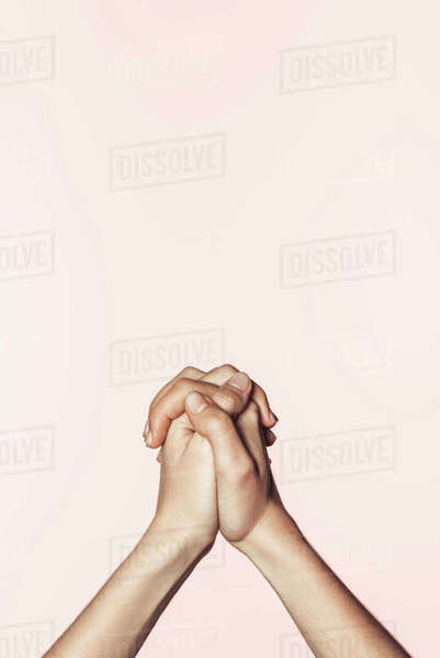 cropped shot of woman holding own hands together isolated on pink ...