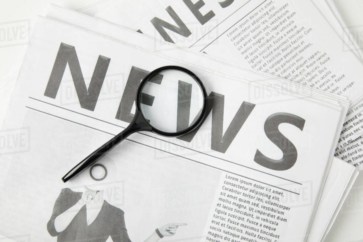 Top view of magnifying glass and newspapers, information concept ...