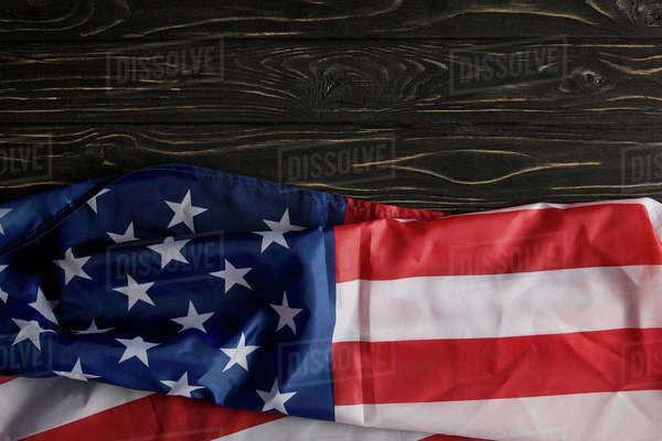 Top view of united states flag on wooden surface - Stock Photo - Dissolve