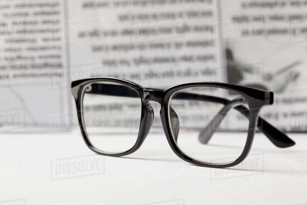 Selective focus of eyeglasses and newspaper on background - Royalty ...