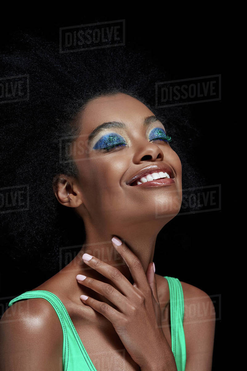portrait of smiling african american model with bright blue eyes ...