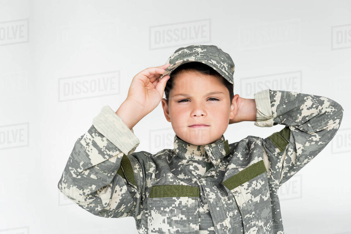 portrait of little kid in military uniform posing on grey background ...
