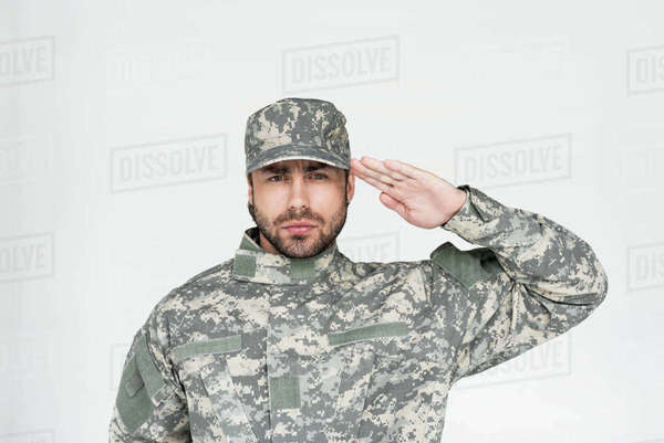 portrait of confident bearded soldier in military uniform saluting ...