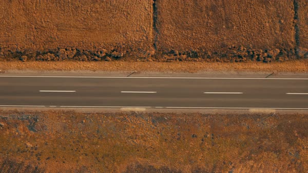 Aerial top shot of cars driving on an straight regional road - Stock ...