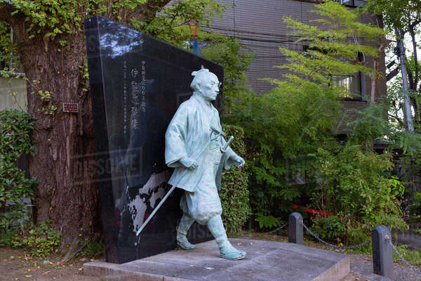 A Japanese stone statue at Tomioka Shrine with copyspace - Royalty-free ...