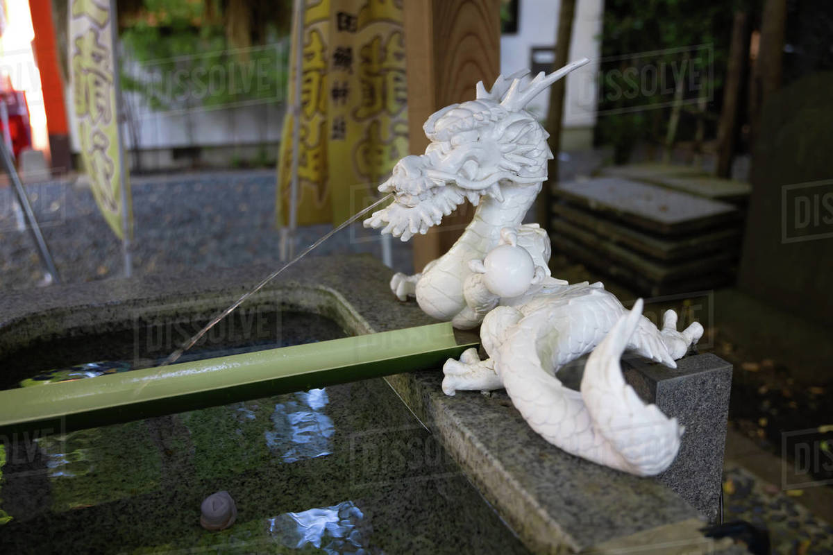 A statue of dragon at purification fountain in Japanese Shrine - Stock ...