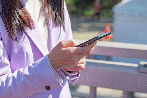 Body parts of hands using smartphne by Japanese woman at the street ...