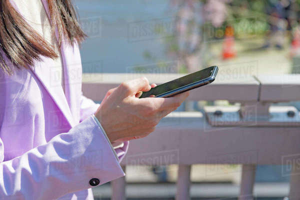 Body parts of hands using smartphne by Japanese woman at the street ...