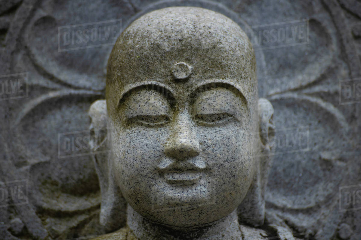 A religious stone statue of Jizo at Japanese buddhism temple - Royalty ...