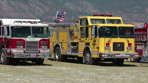 Fire trucks ready to respond to forest wild fire. Fire intense flames ...