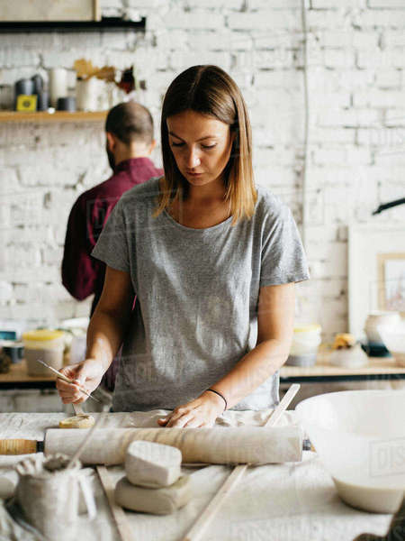 Female maker ceramics working with clay and creating a shape of ceramic ...