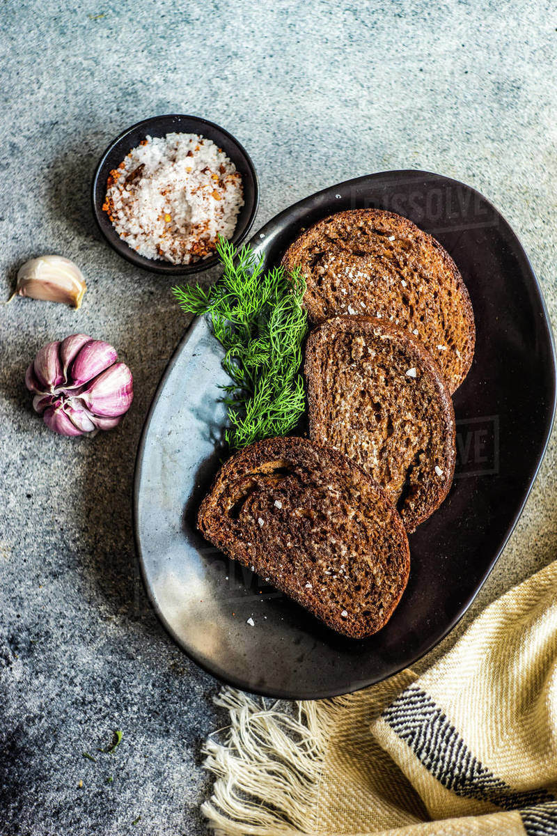 Overhead view of toasted rye bread with garlic and sea salt - Royalty ...