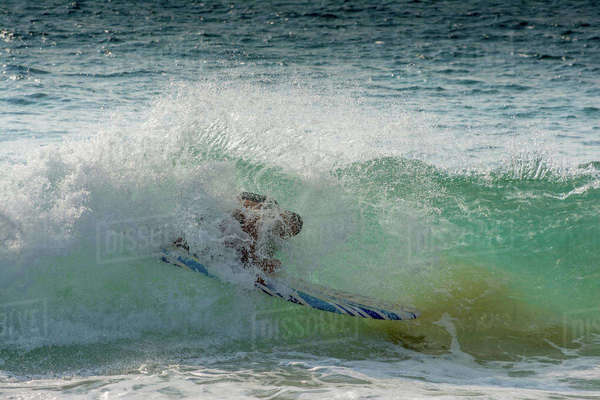 Close-up of a surfer falling off a surfboard in ocean, Maui, Hawaii ...