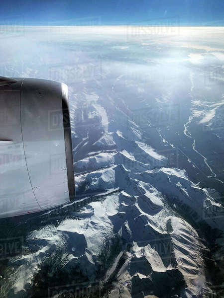Aerial view of an aircraft engine flying over Canadian Rocky Mountains ...
