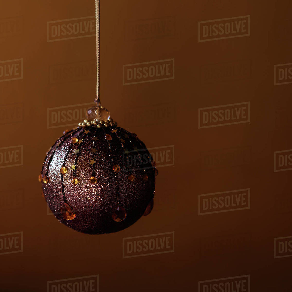 Christmas bauble hanging on string - Stock Photo - Dissolve