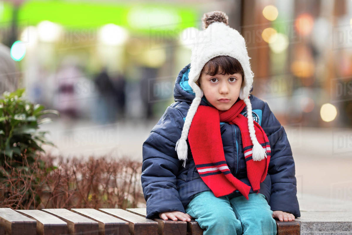 Sad boy sitting on a bench - Royalty-free Stock Photo | Dissolve