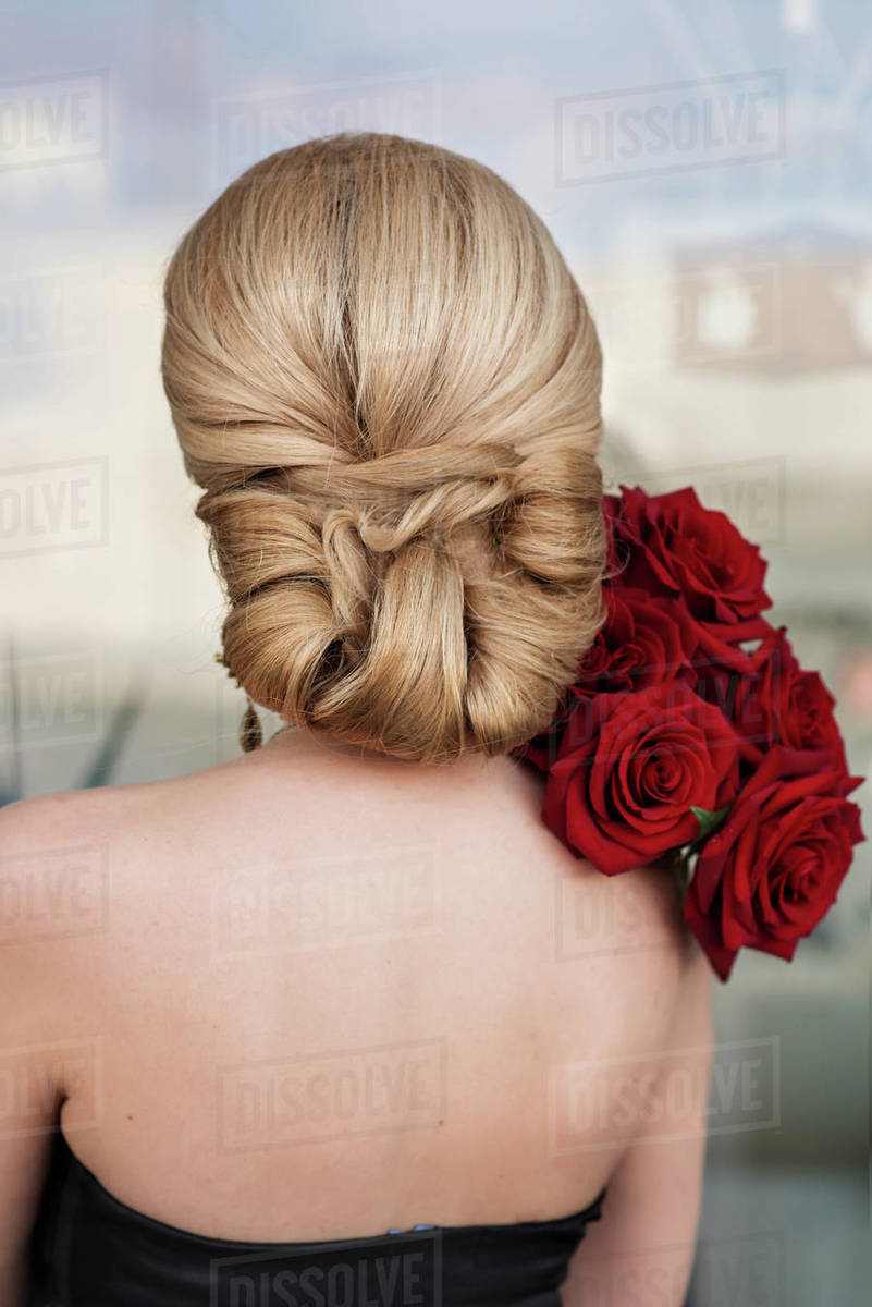 Rear view of a woman holding a bunch of red roses - Royalty-free Stock ...