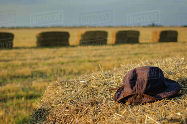 Hat on a hay bale - Royalty-free Stock Photo | Dissolve