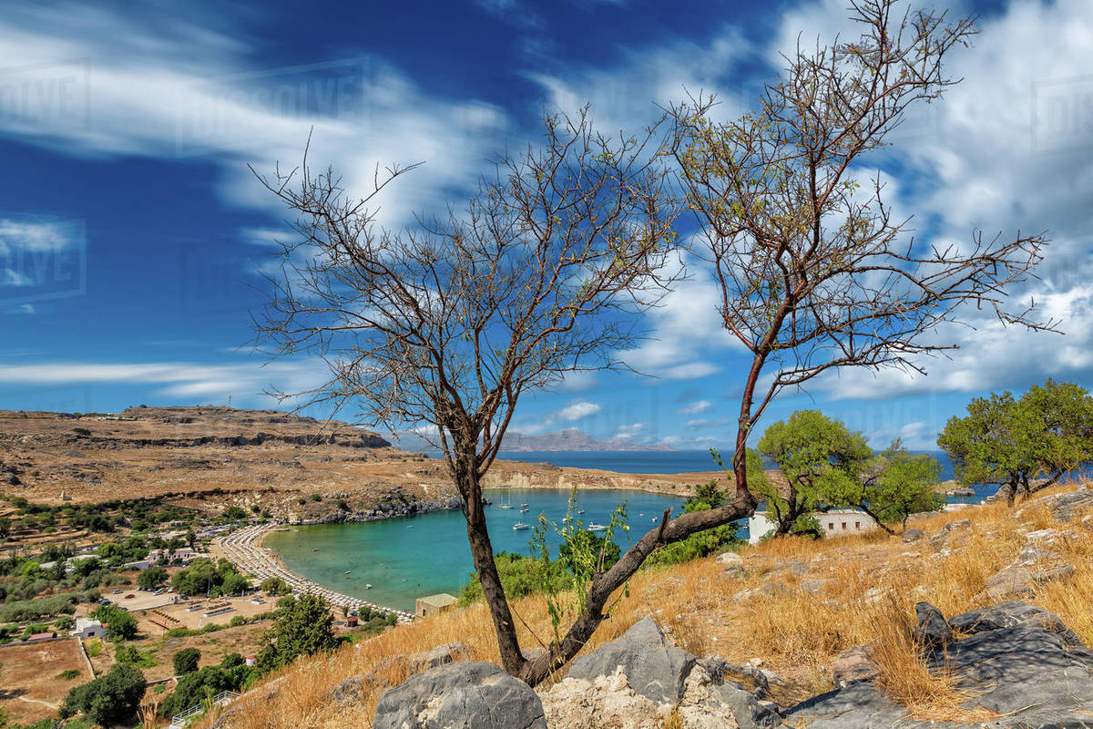 Beach and harbor in Lindos, Rhodes, Greece - Stock Photo - Dissolve