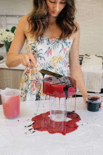 Woman glazing a home made red velvet chocolate cake - Royalty-free ...
