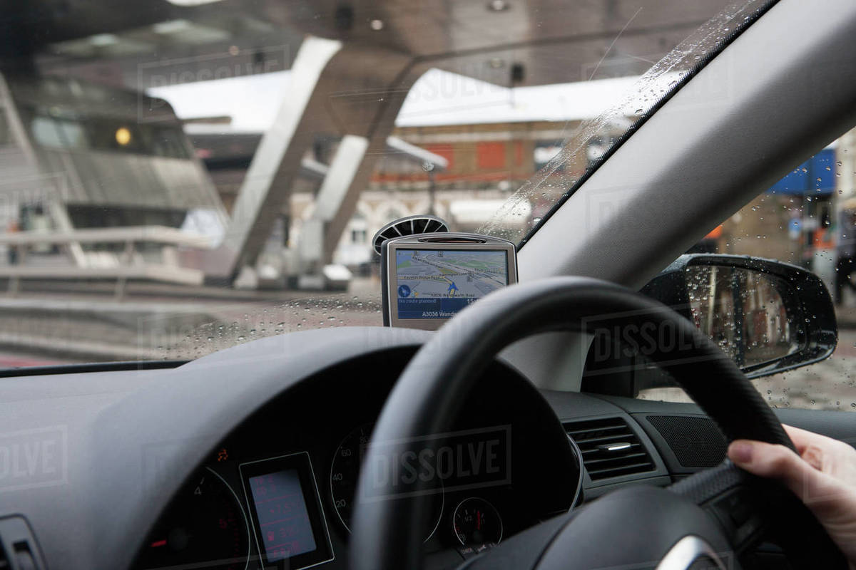 Person using car global positioning system to navigate city - Stock ...