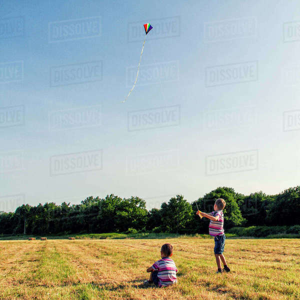 Two boys flying a kite - Royalty-free Stock Photo | Dissolve