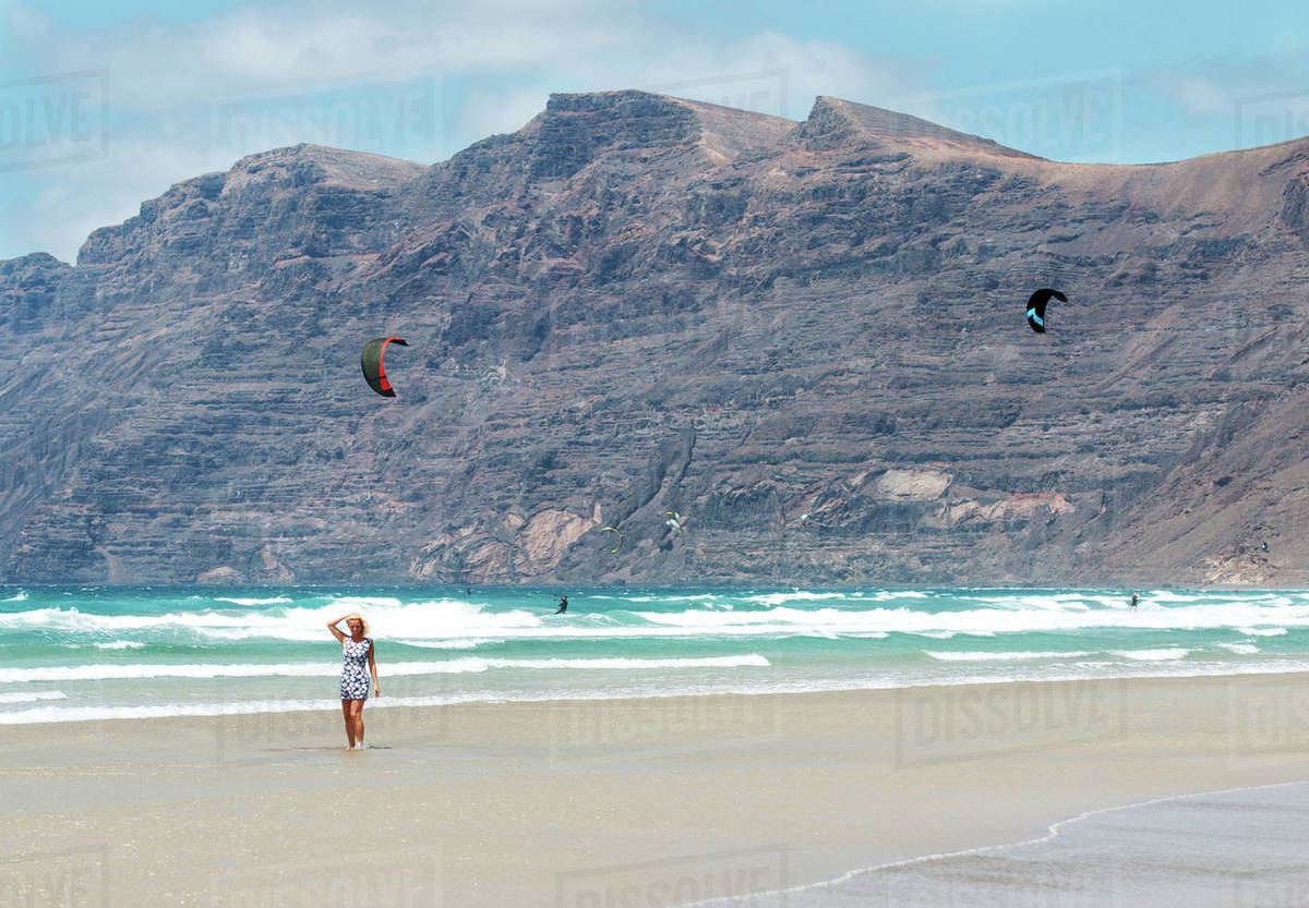 Beautiful woman in a summer dress on Famara beach, Lanzarote, Canary ...