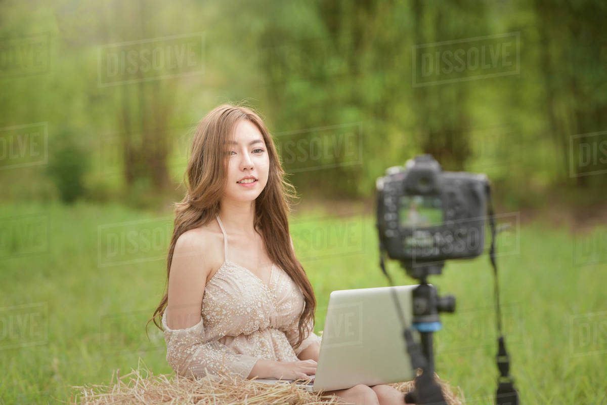 Vlogger filming outdoors, Thailand - Royalty-free Stock Photo | Dissolve