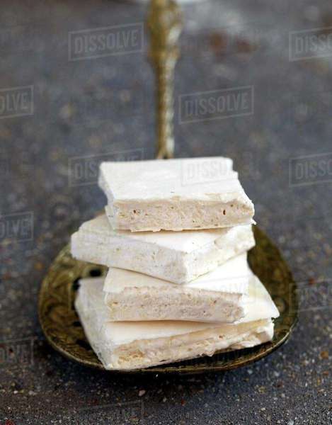 White, plain nougat on vintage spoon - Stock Photo - Dissolve