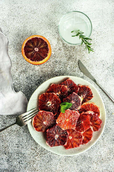 Overhead view of a plate of peeled and sliced Sicilian blood oranges ...