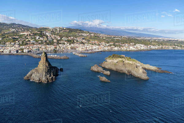 Sea stacks off Acitrezza with Mt Etna in distance, Catania, Sicily ...