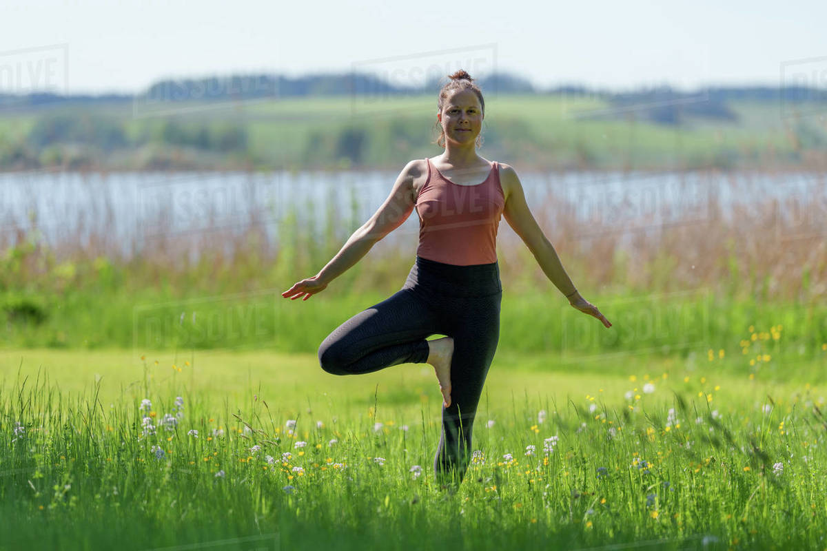 Woman doing tree pose by Wallersee, Salzburg, Austria - Stock Photo ...