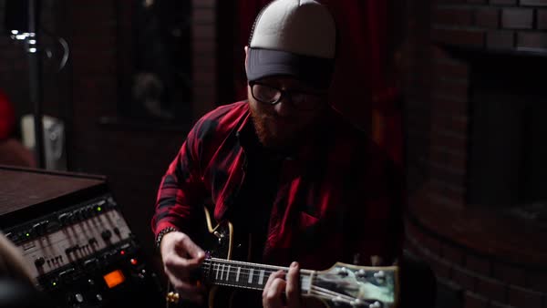 Stylish musician wearing cap and glasses enjoying performing favorite ...