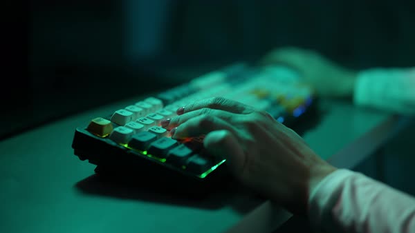 Cropped shot of unrecognizable female hacker typing on wireless RGB ...