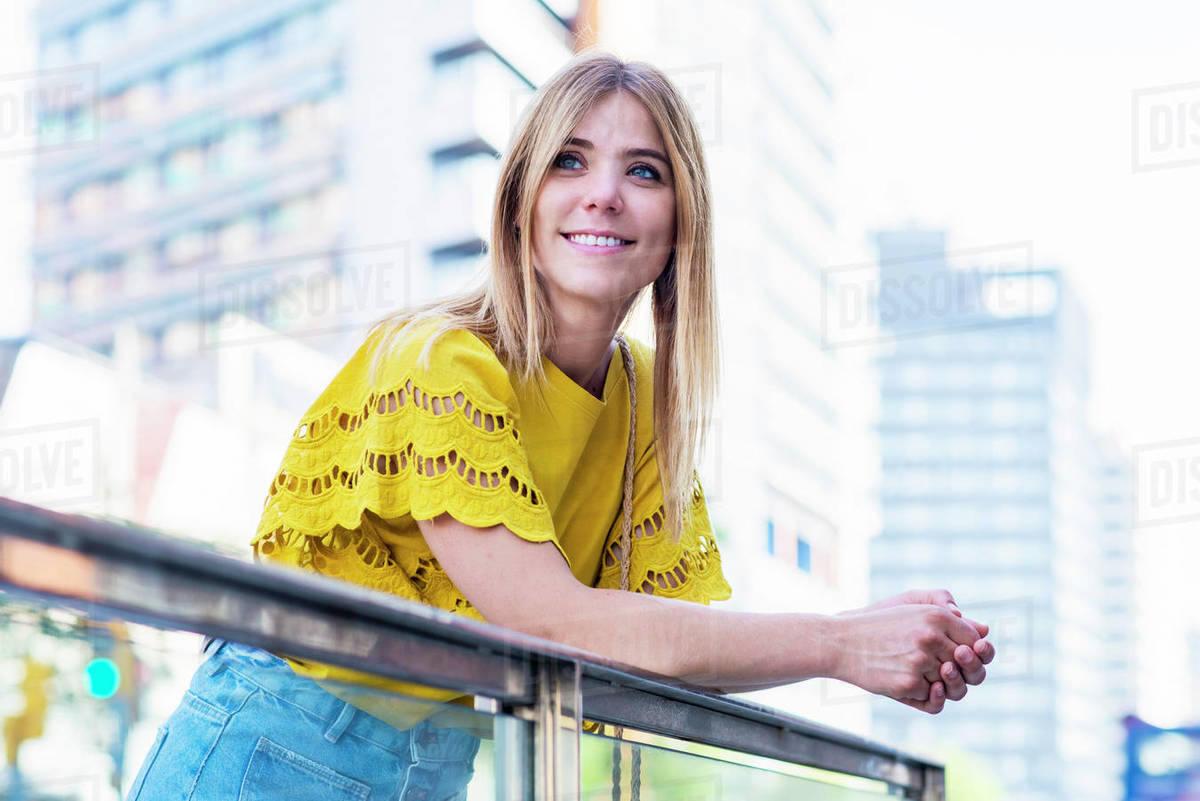 Cheerful beautiful female model smiling and looking away - Royalty-free ...