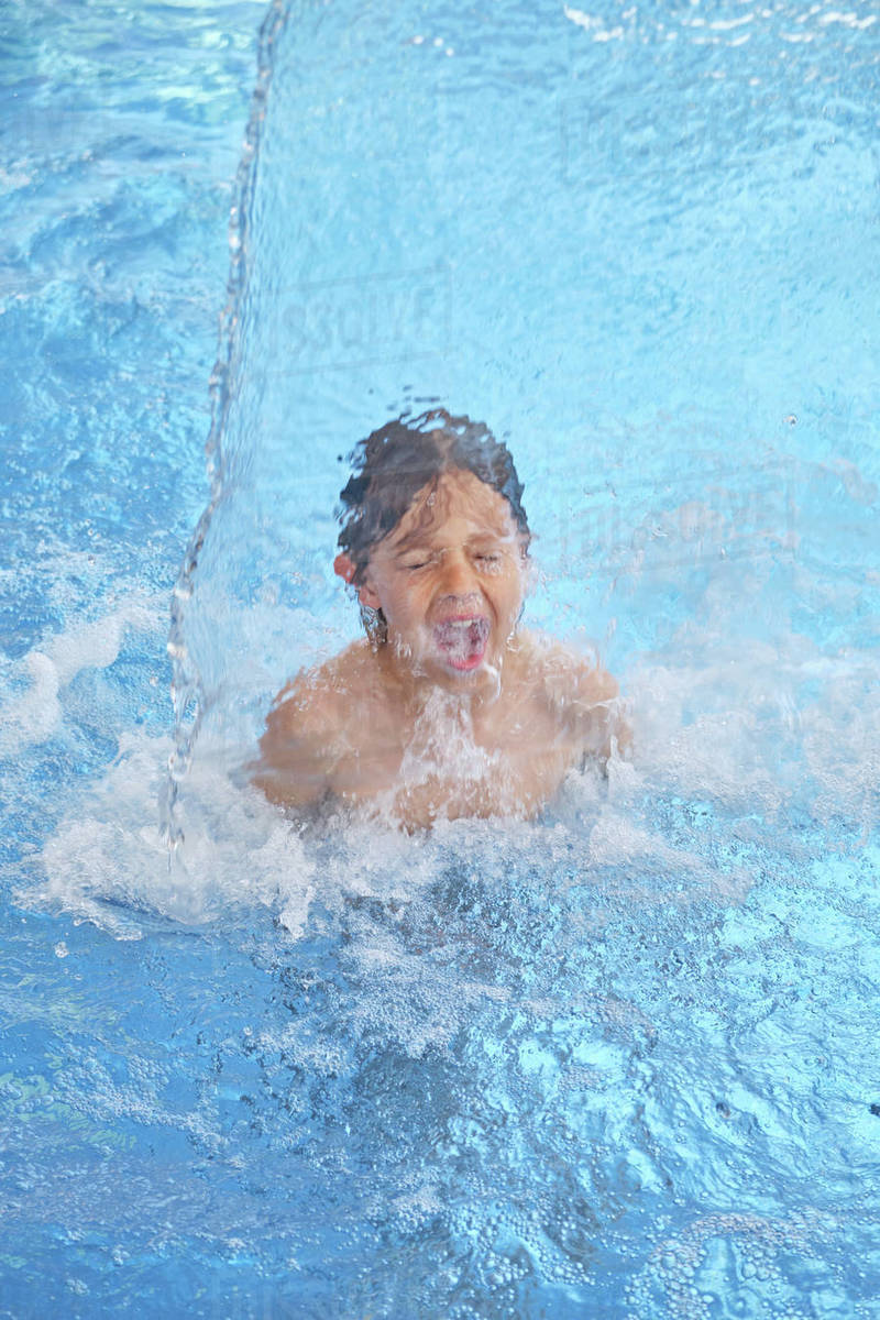 Child gasping for air with closed eyes and open mouth while floating ...