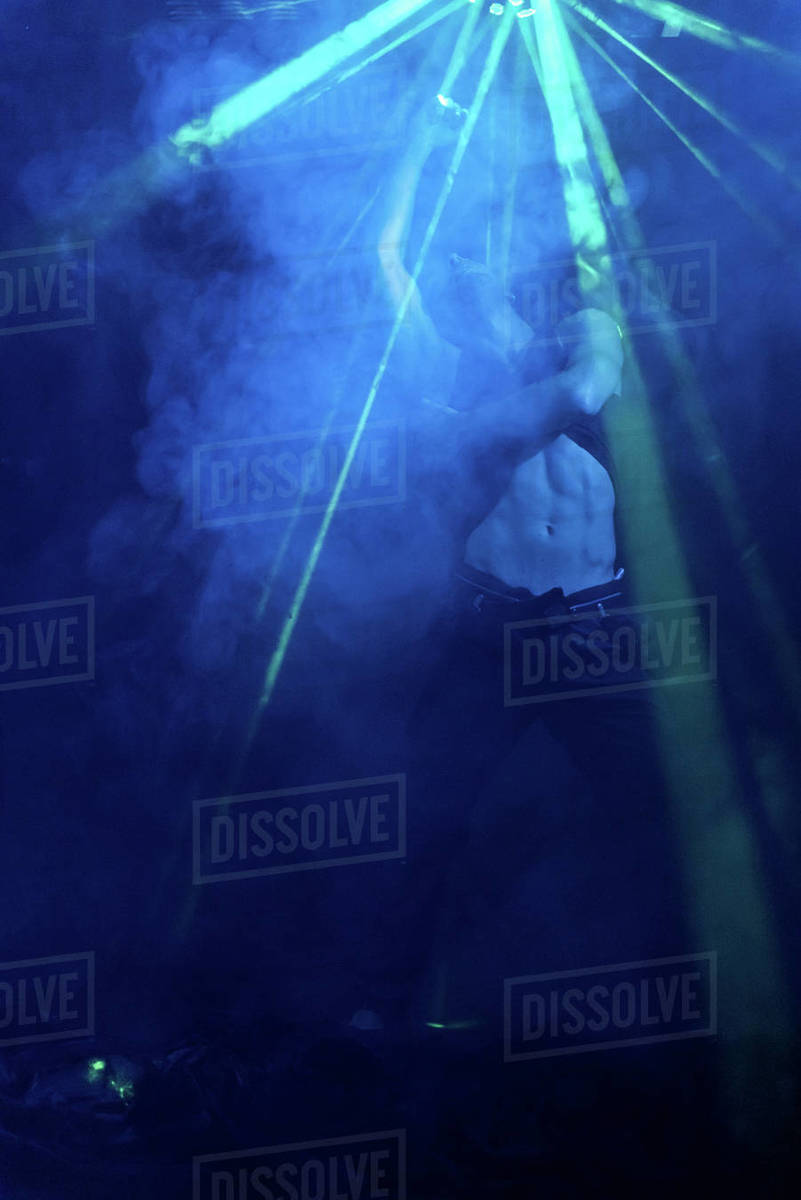 Full body of unrecognizable muscular shirtless male enthusiastically ...