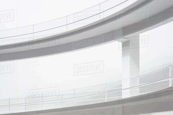 White smooth ramps or inclines with railings located outside modern ...