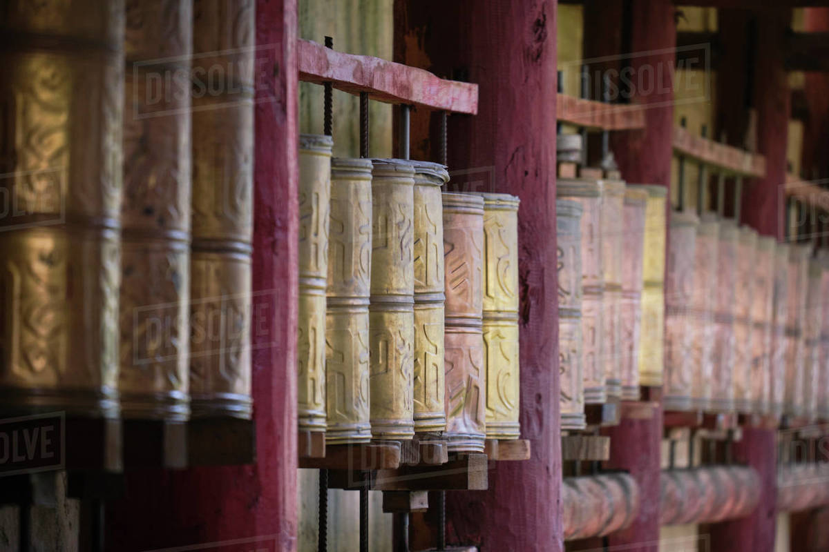 Old stone Tibetan rolls with sacred mantra consisting of sanskrit ...