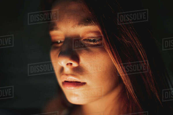 Closeup of thinking sensual young woman looking at flame thoughtful ...