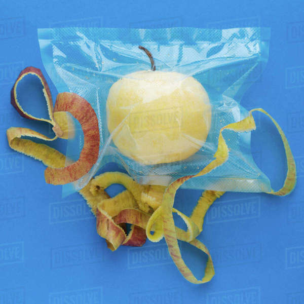 Top view of ripe yellow peeled apple in vacuum plastic bag and apple ...