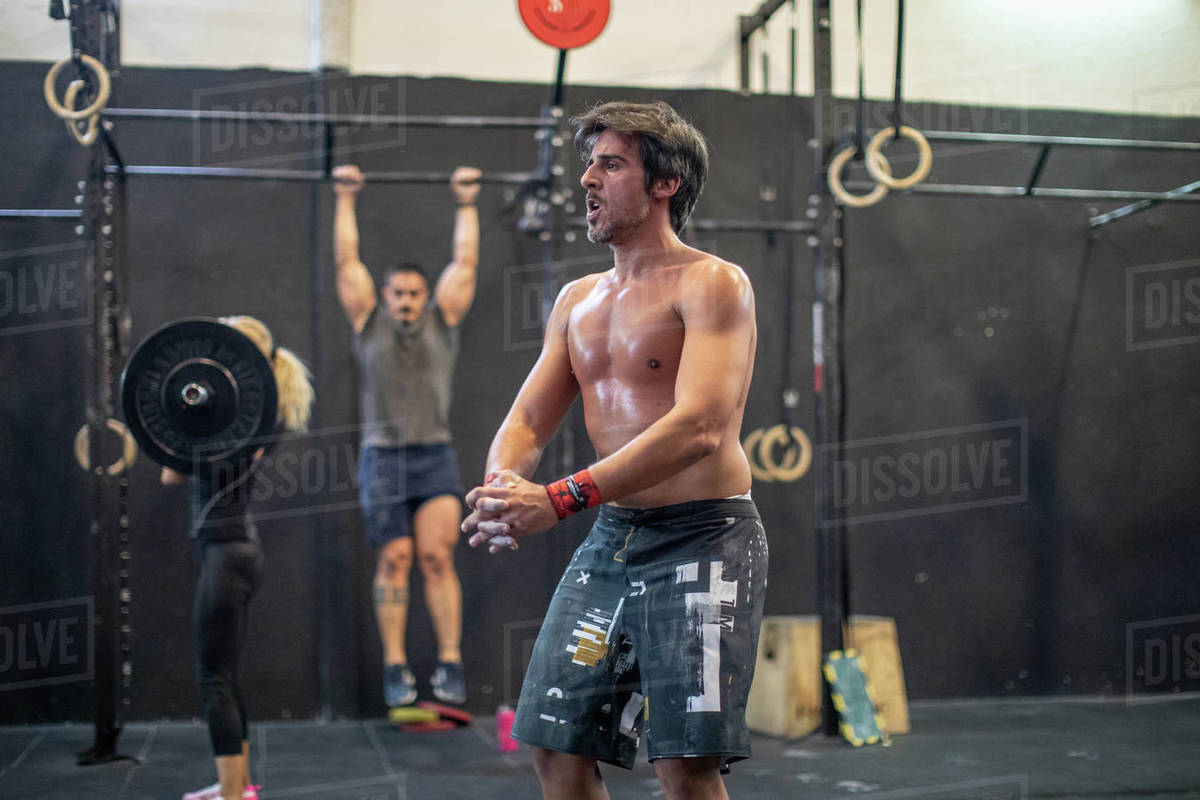 Tired man standing in gym - Royalty-free Stock Photo | Dissolve
